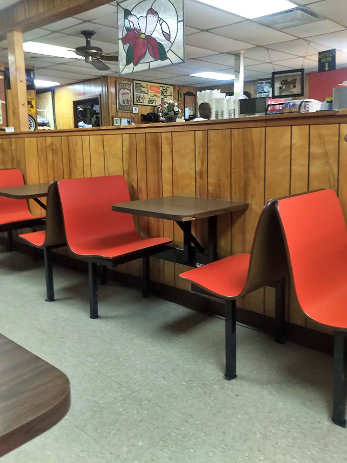 Those red chairs have cradled generations of happy diners. Simple, functional, and as unpretentious as the food itself.