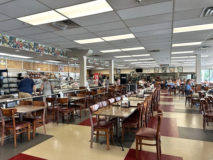 The bustling main dining area where strangers become neighbors. Red and cream checkered floors have witnessed countless first bites and satisfied sighs.
