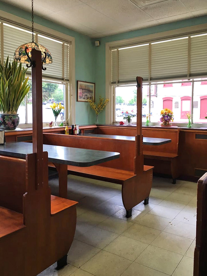 Mint walls and wooden booths create a dining room where time slows down just enough to savor both your meal and the conversation.