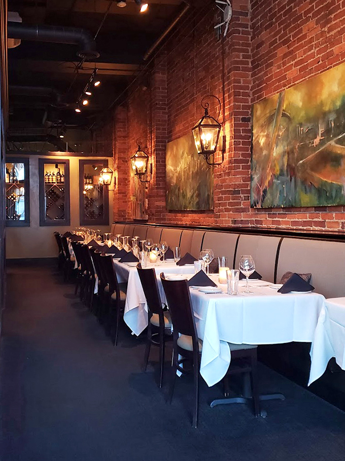 The dining room's exposed brick and white tablecloths create that rare atmosphere where both celebration and Tuesday night dinner feel equally at home.