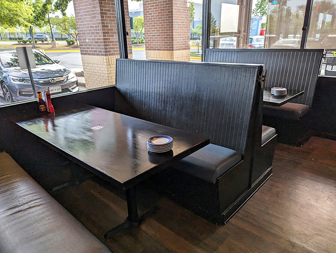 Dark wood booths offer the perfect setting for intimate conversations or passionate debates about whether Connecticut or Maine-style lobster rolls reign supreme.
