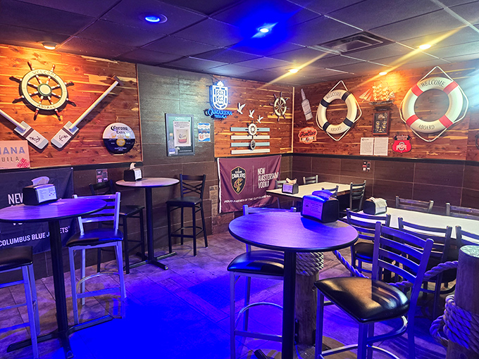 Nautical wheels and life preservers adorn the walls of this cozy seating area, perfect for enjoying drinks before diving into dinner.