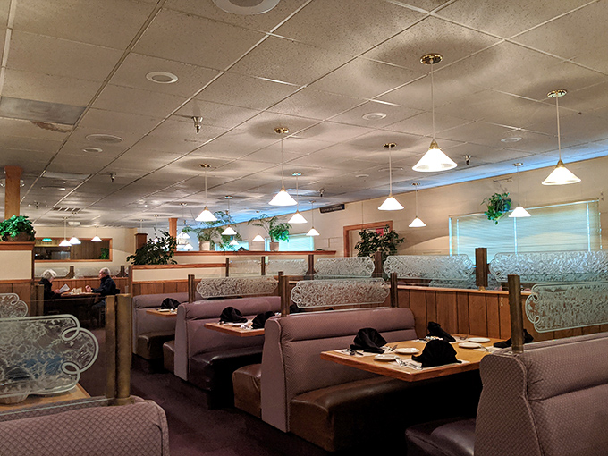 Comfortable booths create intimate dining islands where conversations flow as freely as the wine.