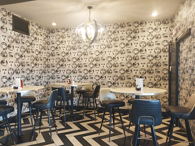That face-patterned wallpaper watches over diners like a quirky guardian angel. The perfect conversation starter when your Tinder date hits an awkward silence.