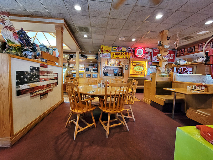 The American flag display watches over diners like a patriotic guardian. These wooden chairs have supported generations of satisfied breakfast enthusiasts.