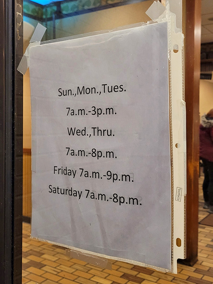 Hours posted with the confidence of a place that knows exactly what it is. The handwritten sign speaks volumes about priorities: food first, fancy presentation second.