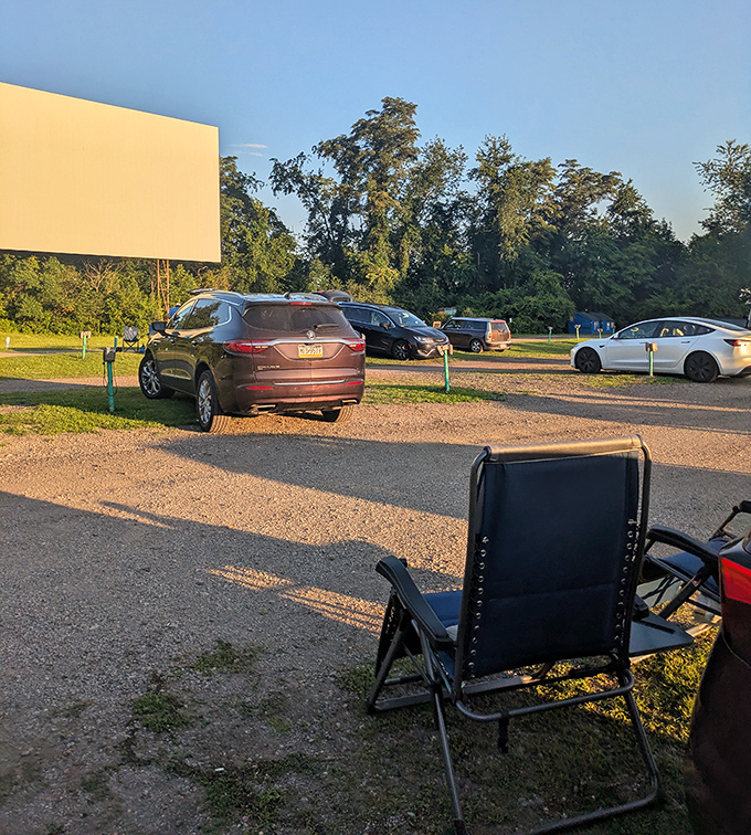 The calm before the cinematic storm—empty chairs waiting for movie lovers while the blank screen holds infinite possibilities.