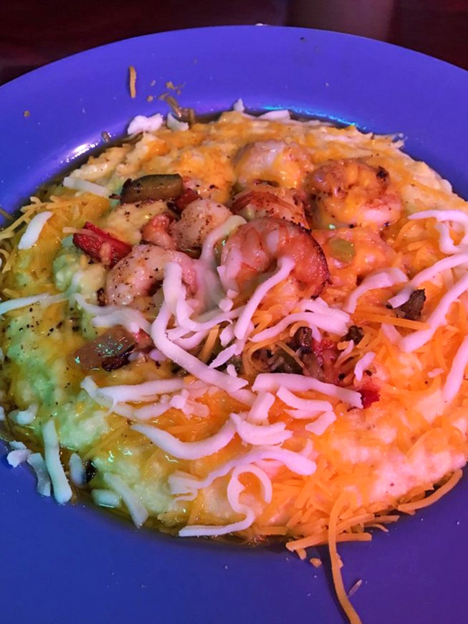 Shrimp and grits that tell the story of Southern comfort in a blue bowl of cheesy, buttery perfection.