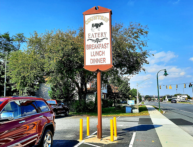 The roadside sign promises three essential food groups: breakfast, lunch, and dinner. That cow silhouette knows what's good.