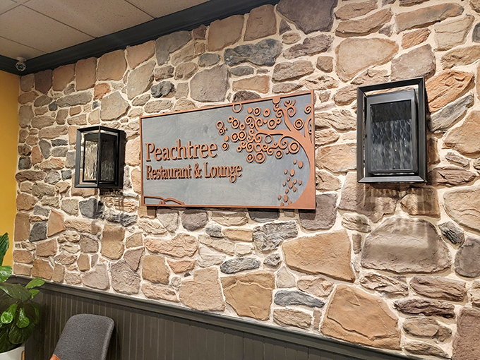 The Peachtree sign against natural stone&mdash;like a modern masterpiece in a classical frame. Elegant yet approachable, just like their menu.