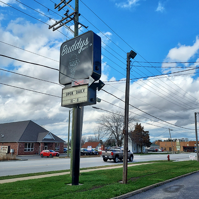 Buddy's roadside sign serves as a beacon for hungry travelers and locals alike, its "Open Daily" promise more comforting than any luxury hotel's turndown service.