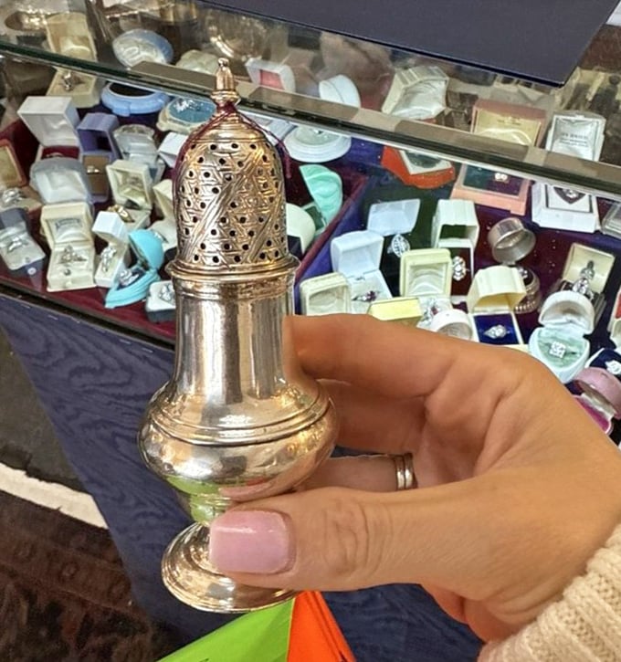 This delicate silver shaker once graced someone's formal dining table, a reminder of when even everyday objects were crafted with extraordinary attention to detail.