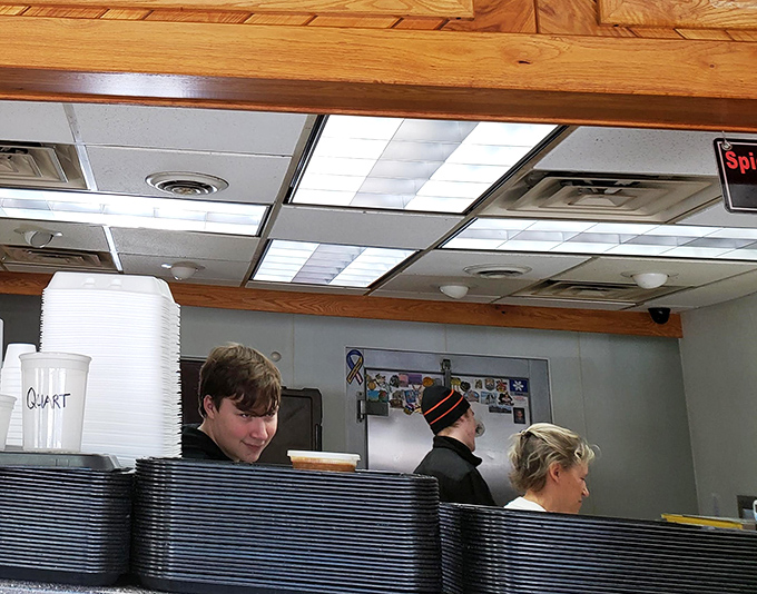 Behind the counter, where barbecue magic happens. These aren't just workers&mdash;they're keepers of the flame, guardians of the smoke.