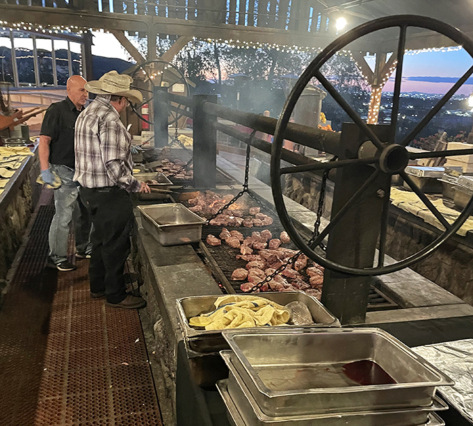 Real cowboys manning the grill with the precision of surgeons. That wheel isn't just for show&mdash;it's barbecue engineering at its finest.