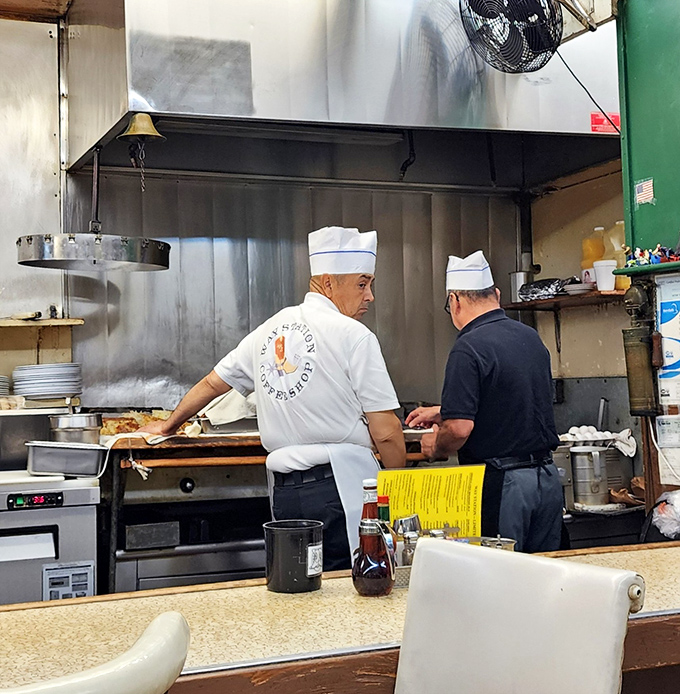 Chefs in their natural habitat, orchestrating breakfast symphonies with the confidence that comes from thousands of perfectly flipped eggs.