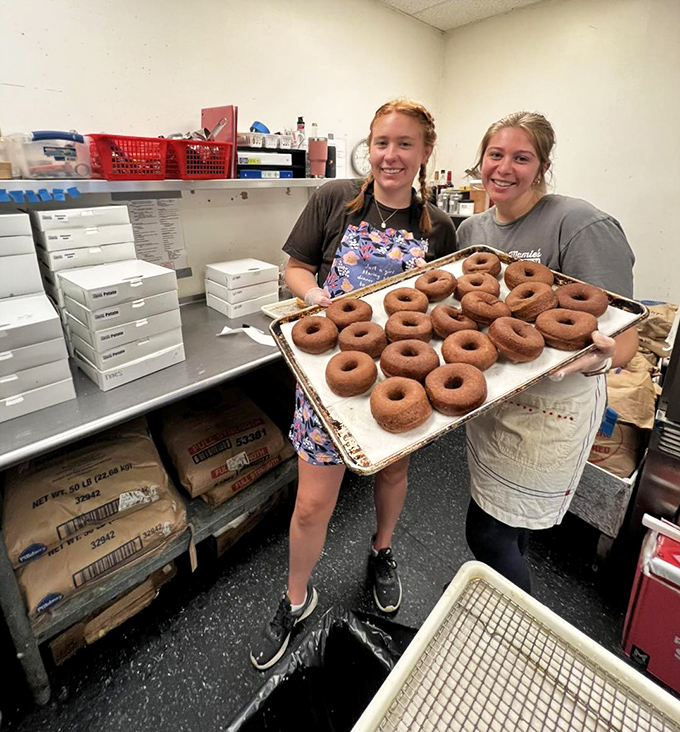 The bakers behind the magic, proudly displaying their handiwork. Those donuts didn't achieve that perfect texture by accident&mdash;they were loved into existence.