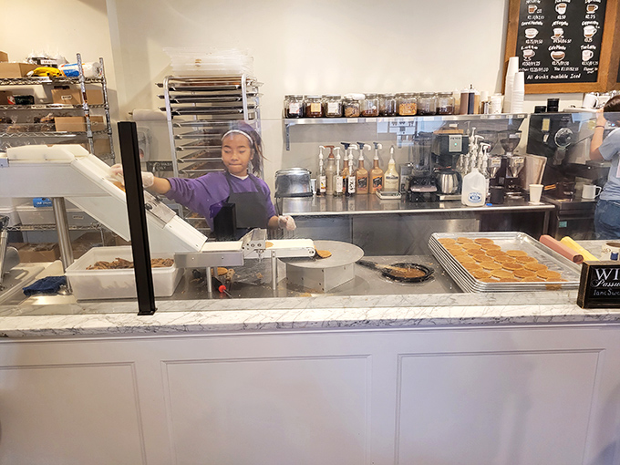 Behind the scenes magic: fresh waffle cones in production, the source of that intoxicating aroma that fills the shop.