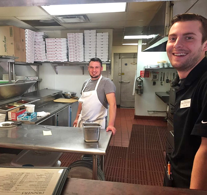 Kitchen heroes in their natural habitat &ndash; where the real magic happens behind those pizza boxes.