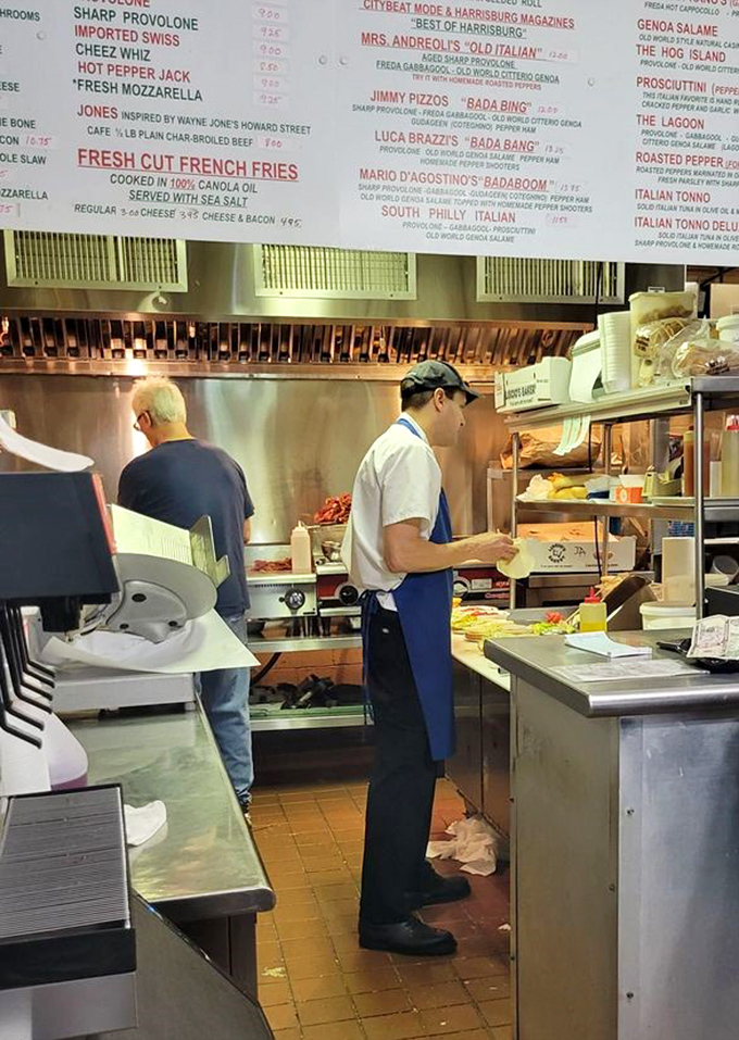 Sandwich artisans at work, creating masterpieces with the focus and precision that only comes from years of perfecting their craft.