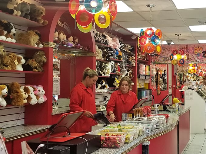 The red-coated candy specialists &ndash; modern-day Willy Wonkas orchestrating sweet symphonies behind gleaming glass. Their job satisfaction is visible.
