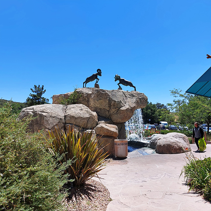 Bighorn sheep sculptures stand guard over a bubbling fountain, adding unexpected wilderness charm to your shopping adventure. Nature meets commerce in perfect harmony.