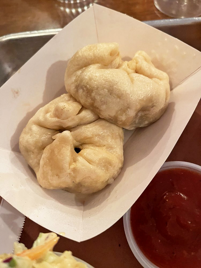 Pillowy steamed buns waiting to be dipped in that vibrant sauce &ndash; Eastern technique meets Western flavors in perfect harmony.