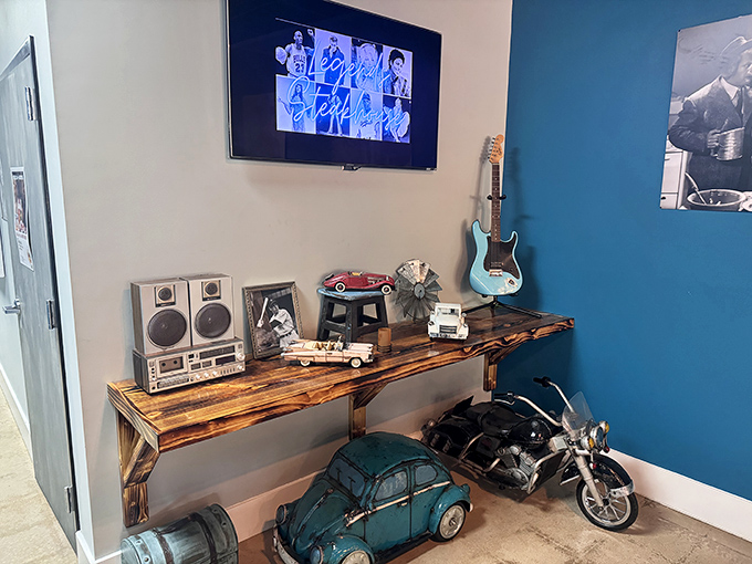 A corner that tells a story&mdash;vintage stereo equipment, model cars, and a guitar create a nostalgic vignette that adds character to the dining experience.
