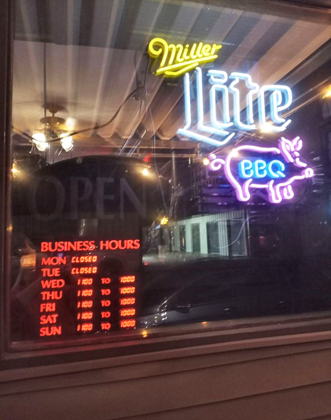 Business hours posted like a promise&mdash;when the smokers are hot, the doors are open, and happiness is served by the plateful.