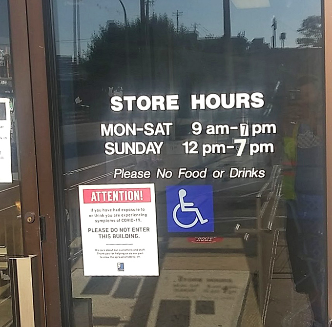 Store hours posted with crystal clarity. The "No Food or Drinks" rule exists because someone once thought shopping with spaghetti was acceptable.