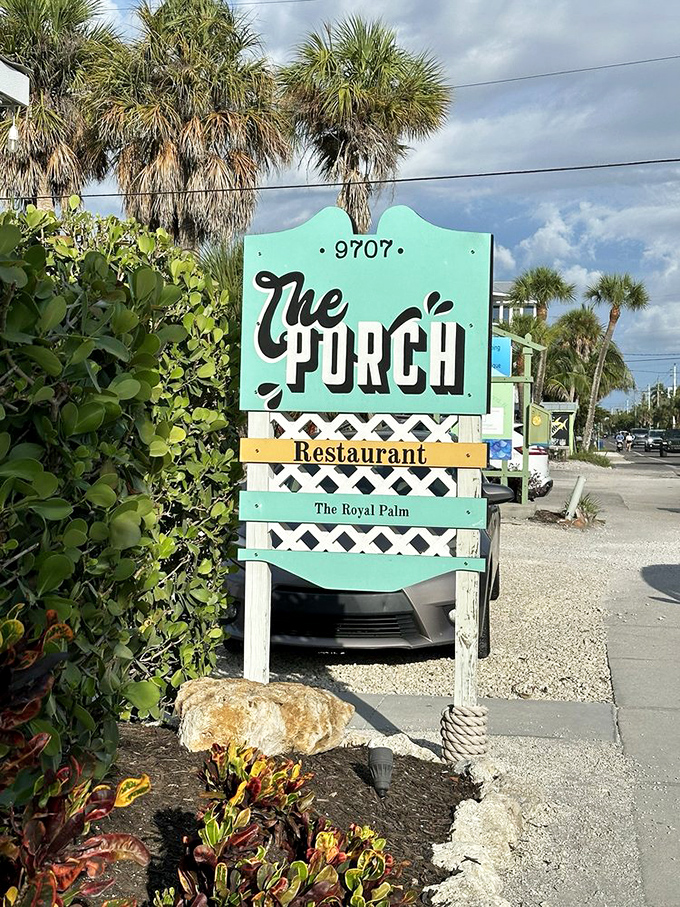 The mint-green sign stands like a beacon of hope for hungry travelers. "The Royal Palm" subtitle adds just the right touch of island elegance.