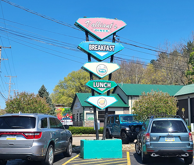 The roadside sign stands tall like a colorful totem pole of temptation. "BREAKFAST" is all the advertising needed.