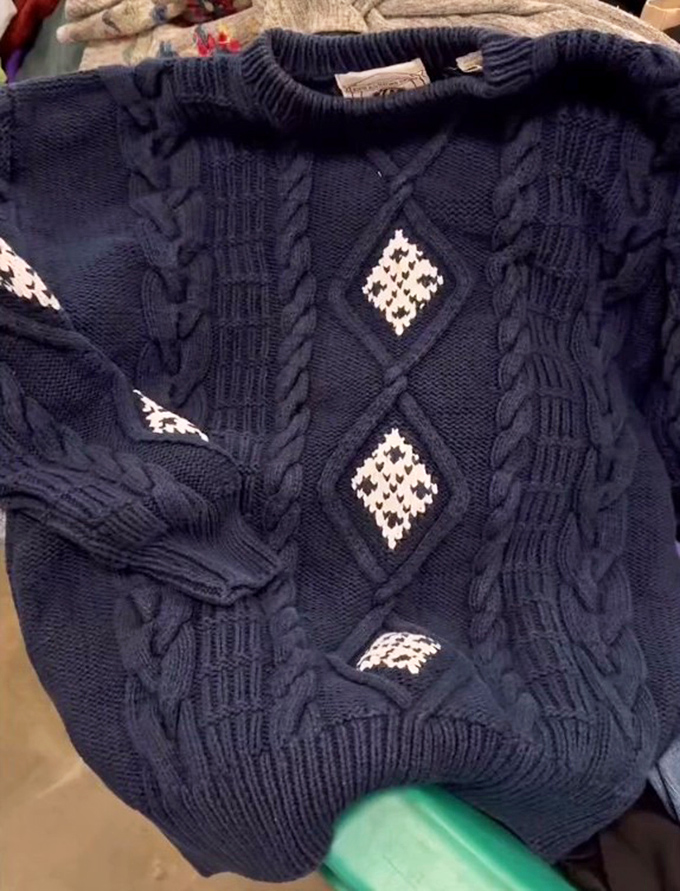 This navy cable-knit sweater with diamond accents isn't just clothing&mdash;it's a wearable hug waiting for its next adventure.