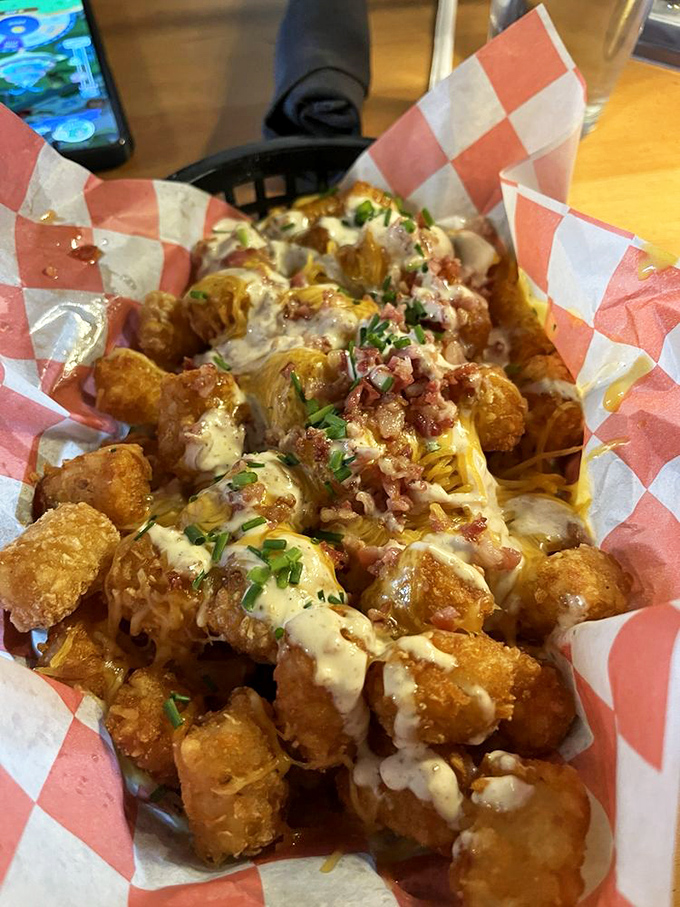 Loaded tavern tots that make French fries jealous&mdash;smothered in cheese, bacon, and chives that transform humble potatoes into a celebration on a plate.
