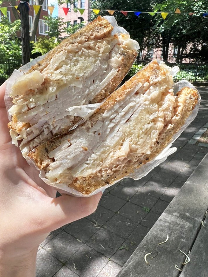 Behold the turkey sandwich in its natural habitat&mdash;layers of thinly sliced meat and sauerkraut creating a portable masterpiece worth traveling for.