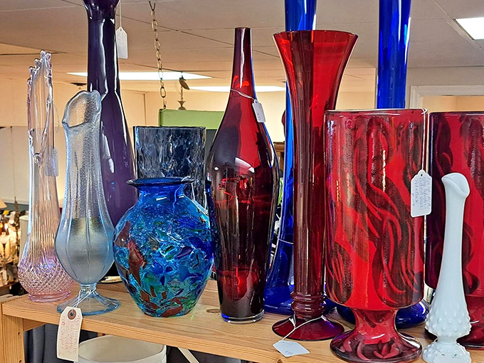 Dramatic art glass vases in jewel tones catch light and imagination. These aren't just vessels&mdash;they're sculptural statements waiting for a single perfect bloom.