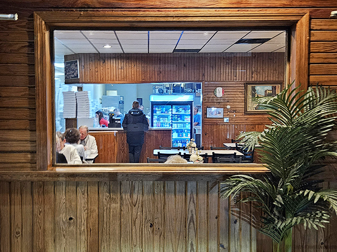 That pass-through window offers a glimpse into the promised land&mdash;where sauces simmer and dough transforms into dreams. Kitchen voyeurism at its most appetizing.