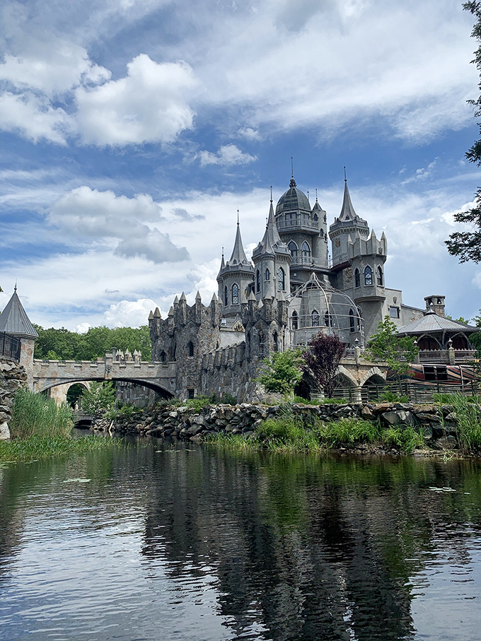 Reflections double the wonder as the castle meets its mirror image in still waters. This moat-side view captures the full fairy tale effect.
