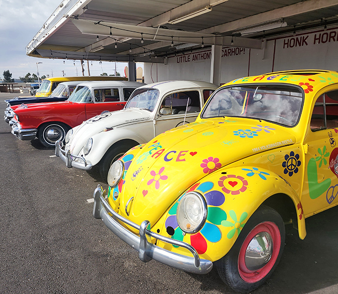 A lineup of vintage beauties that would make any car enthusiast swoon. That flower-power VW Beetle steals the show with its psychedelic charm.
