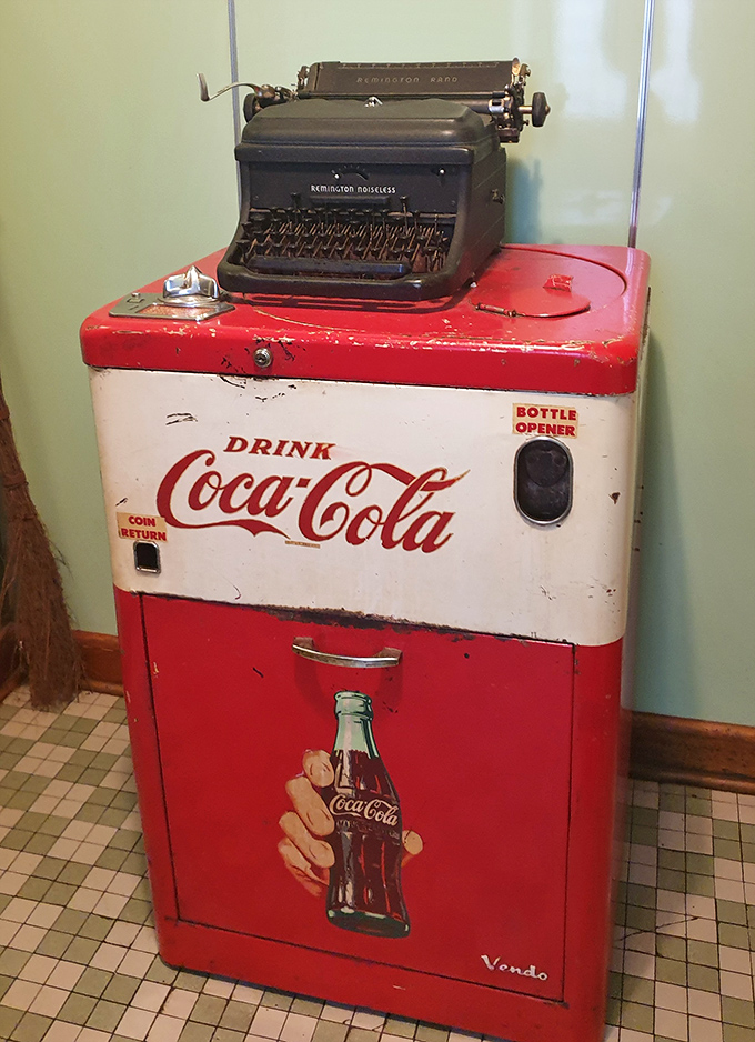Vintage Coca-Cola cooler topped with a typewriter &ndash; d&eacute;cor that tells its own story.