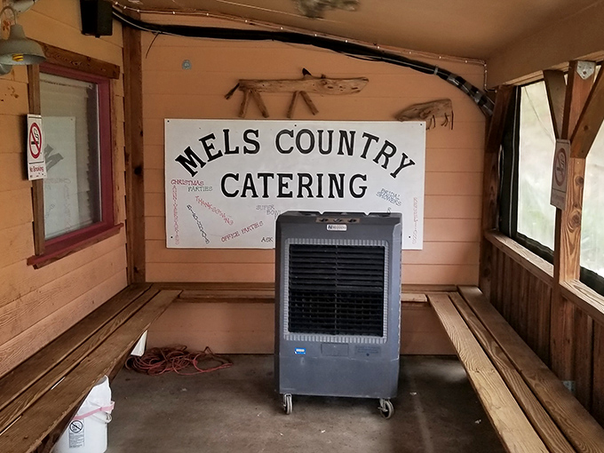 The waiting area's rustic charm and "Mel's Country Catering" sign hint at the establishment's dual identity&mdash;feeding hungry Texans wherever they might gather.