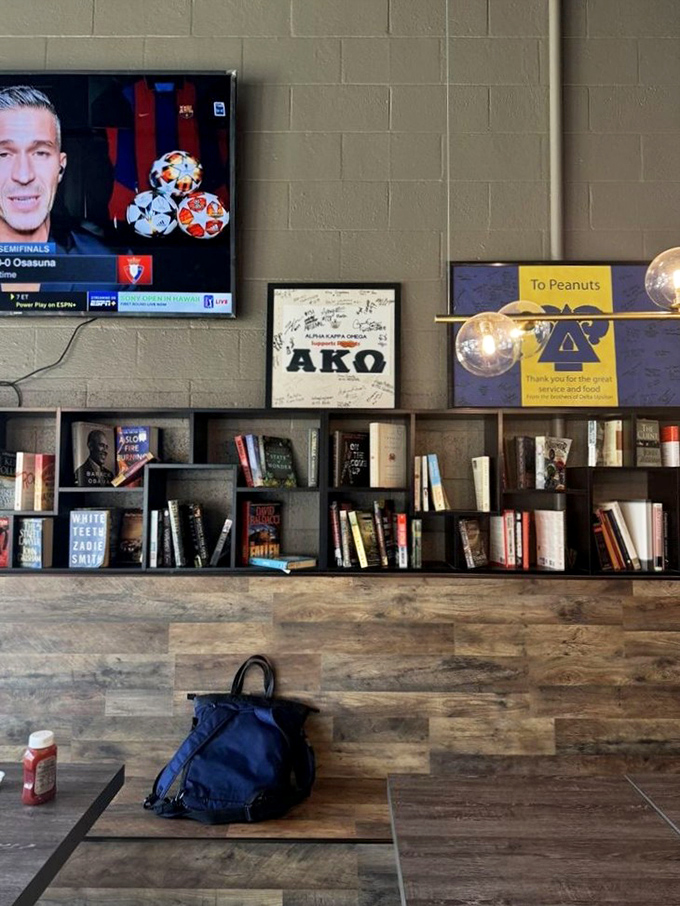 A bookshelf that says, "Stay awhile, we're not just feeding stomachs but minds too." The TV ensures you won't miss the game while feeding your soul.