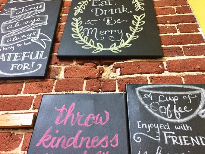 Wall art that reminds you to "throw kindness around" while enjoying coffee with friends&mdash;life lessons served alongside breakfast.