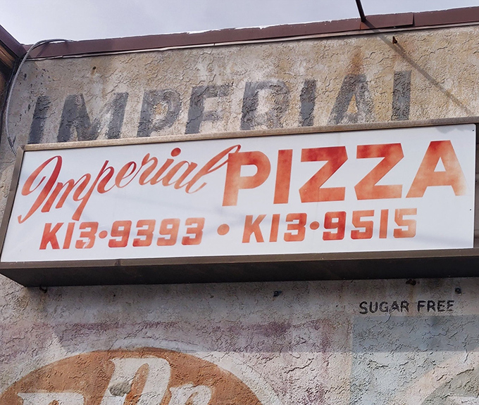 The weathered sign above Imperial Pizza tells a story of decades serving DelCo's pizza faithful. Those phone numbers are etched into local memory like childhood phone numbers.