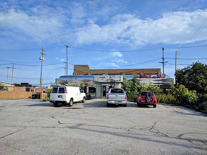 The parking lot view reveals the diner in all its stainless steel glory &ndash; a shining beacon of comfort food standing proudly against Cleveland's ever-changing skyline.