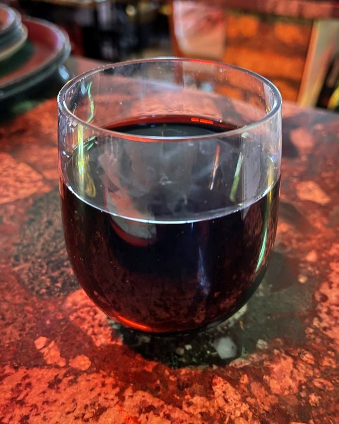 A glass of red wine &ndash; because sometimes beer just isn't enough to celebrate the religious experience that is Pequod's pizza.
