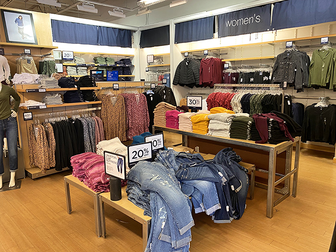 Denim and casual wear arranged with the precision of a retail symphony. The "20% off" sign conducts shoppers through a well-choreographed dance.