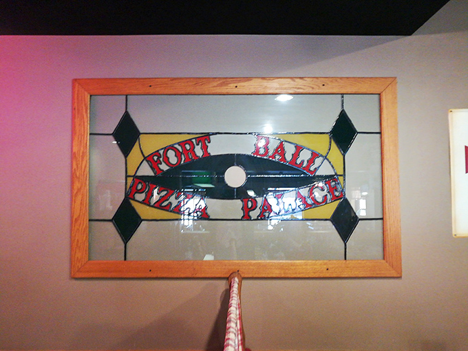 Stained glass signage that elevates "Pizza Palace" from mere restaurant to hallowed institution. Michelangelo would approve.