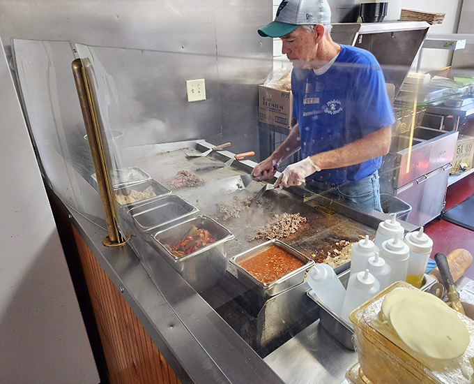 The maestro at work on the flat-top grill. Those spatulas move with the precision and grace of a symphony conductor.