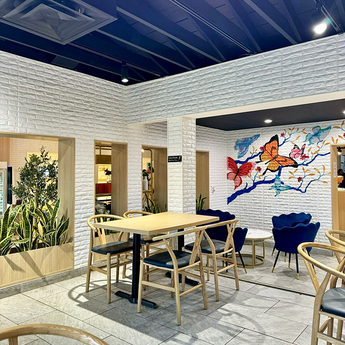 Blue velvet chairs add a pop of color to the serene dining space. It's like eating in a design magazine spread that actually allows food.