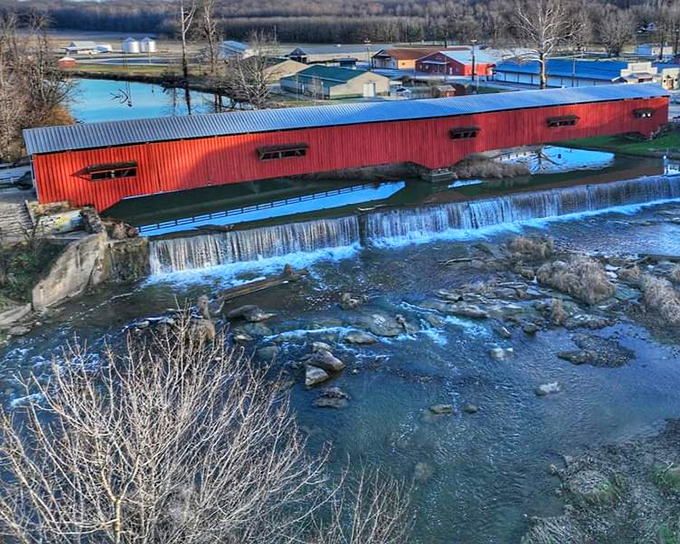 From above, the bridge's striking red exterior contrasts with the blue waters, creating a scene so perfectly Americana it could be on a postage stamp.